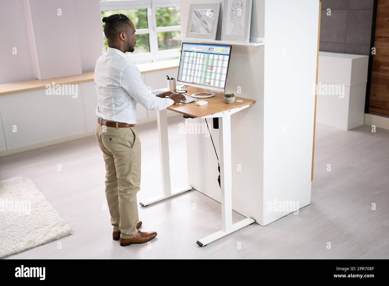 Adjustable Height Desk Stand In Office Stock Photo - Alamy