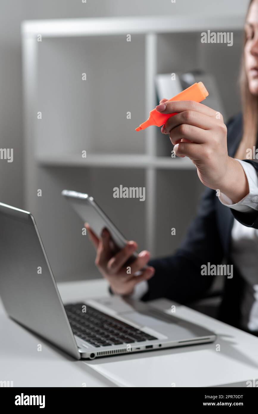 Businesswoman Holding Phone And Pointing With Marker On Important ...
