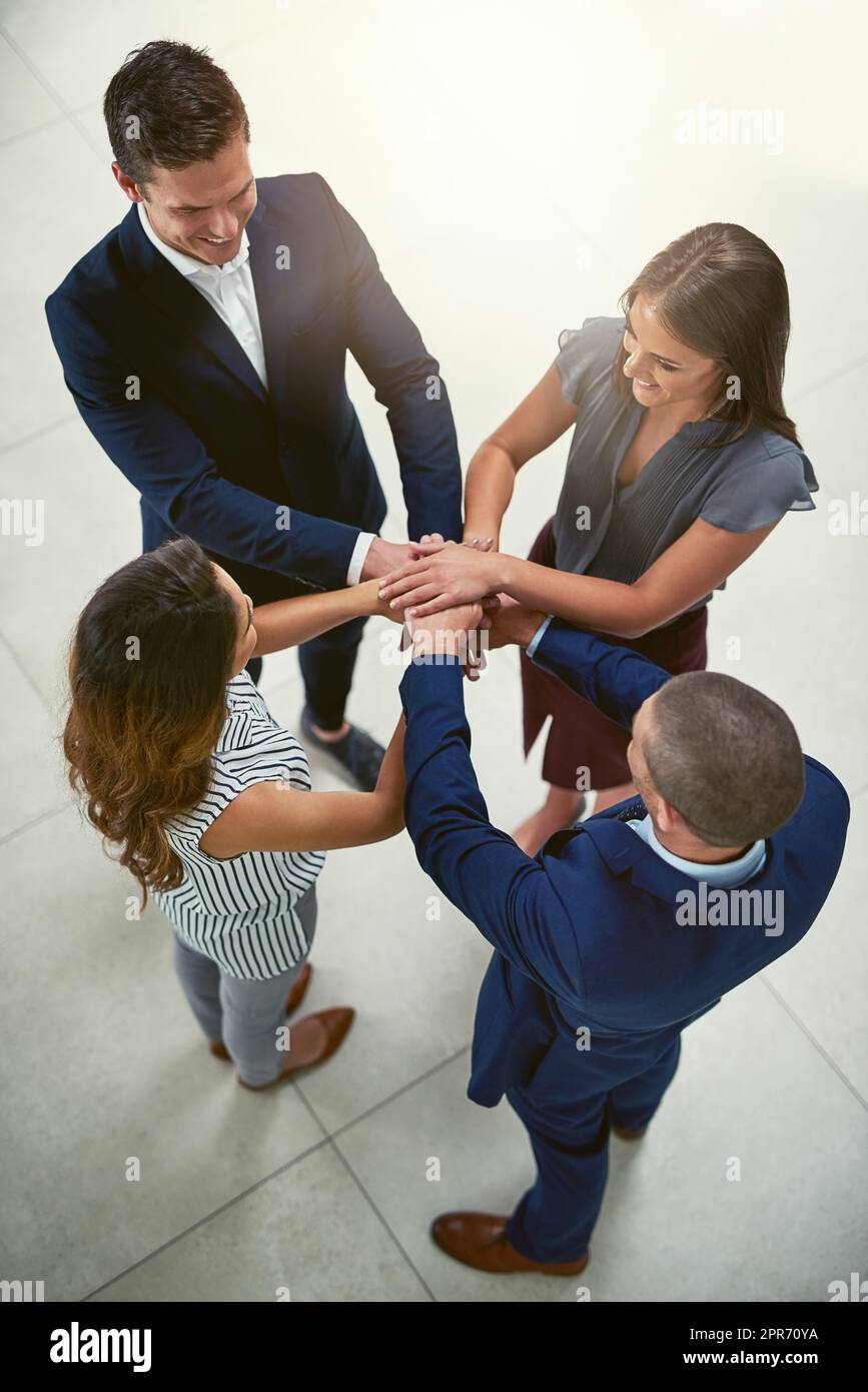 Teamwork is one of the greatest components of success. High angle shot ...