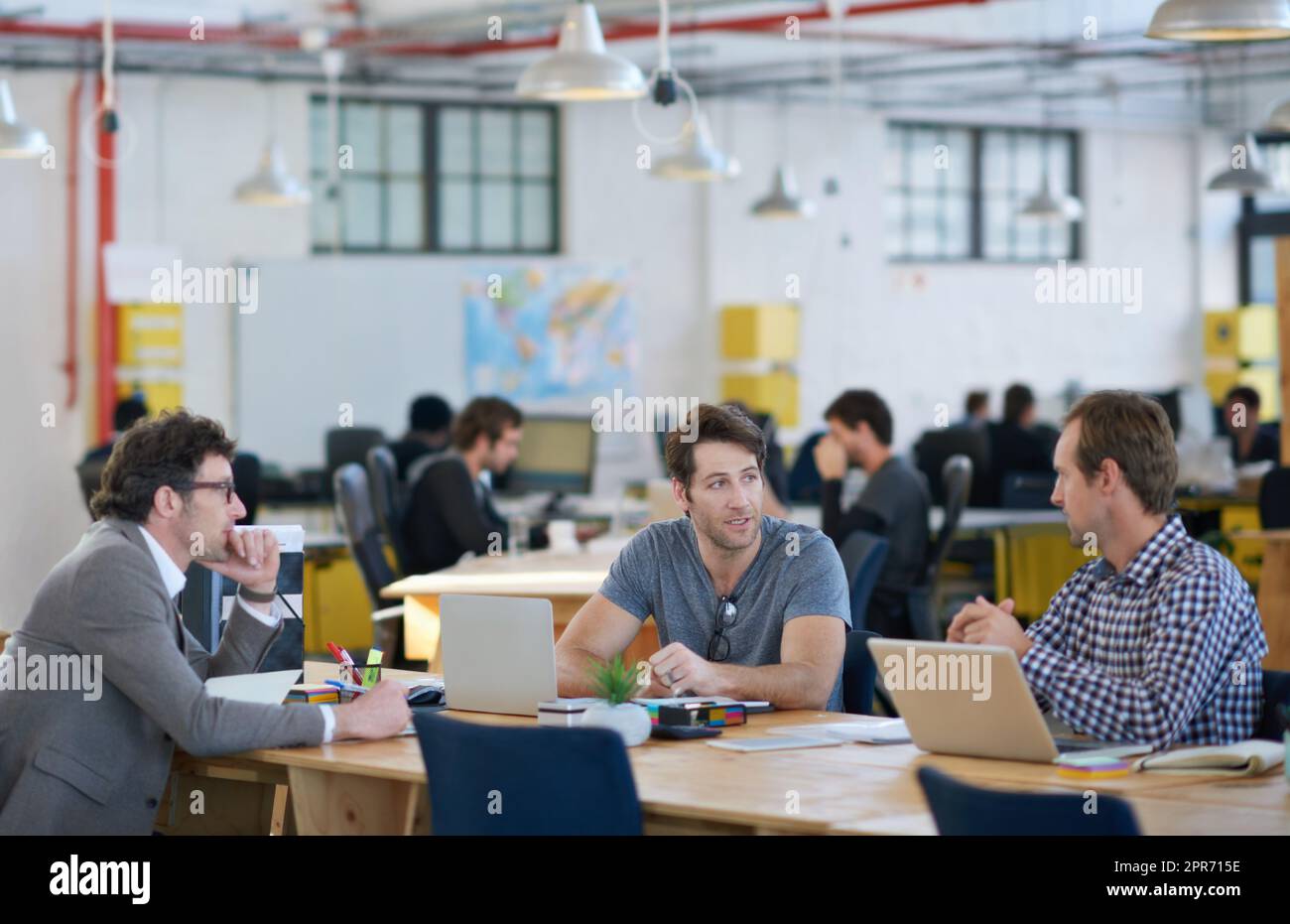 We make technology work for us. Shot of business colleagues discussing ...