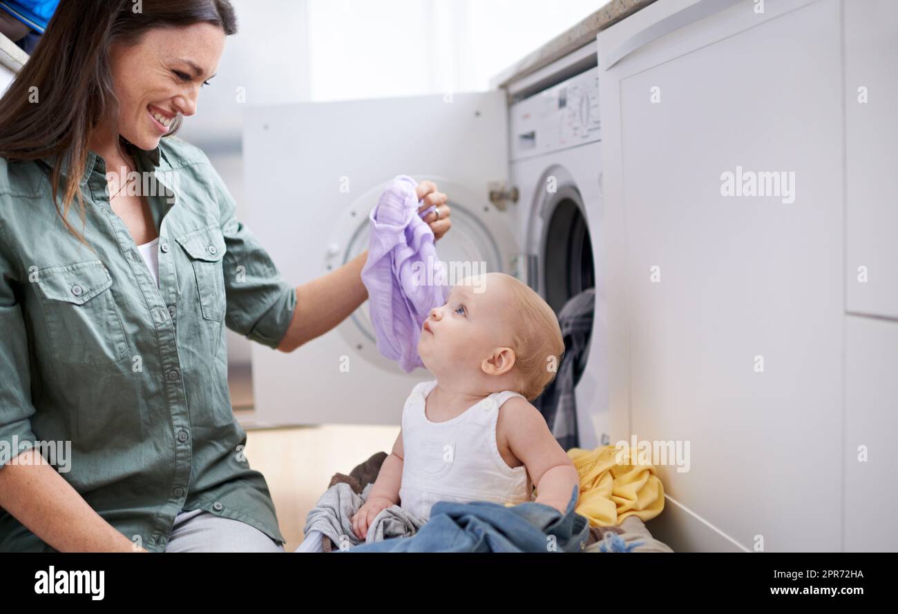 Mommys little helper. Shot of a mother and her baby girl playing while ...