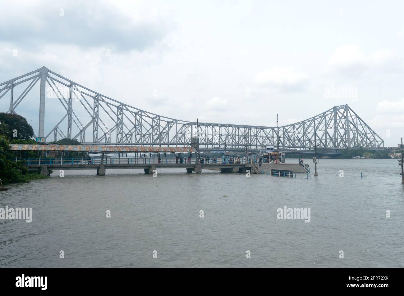 The Howrah Bridge, a balanced attached cantilever bridge covering over ...