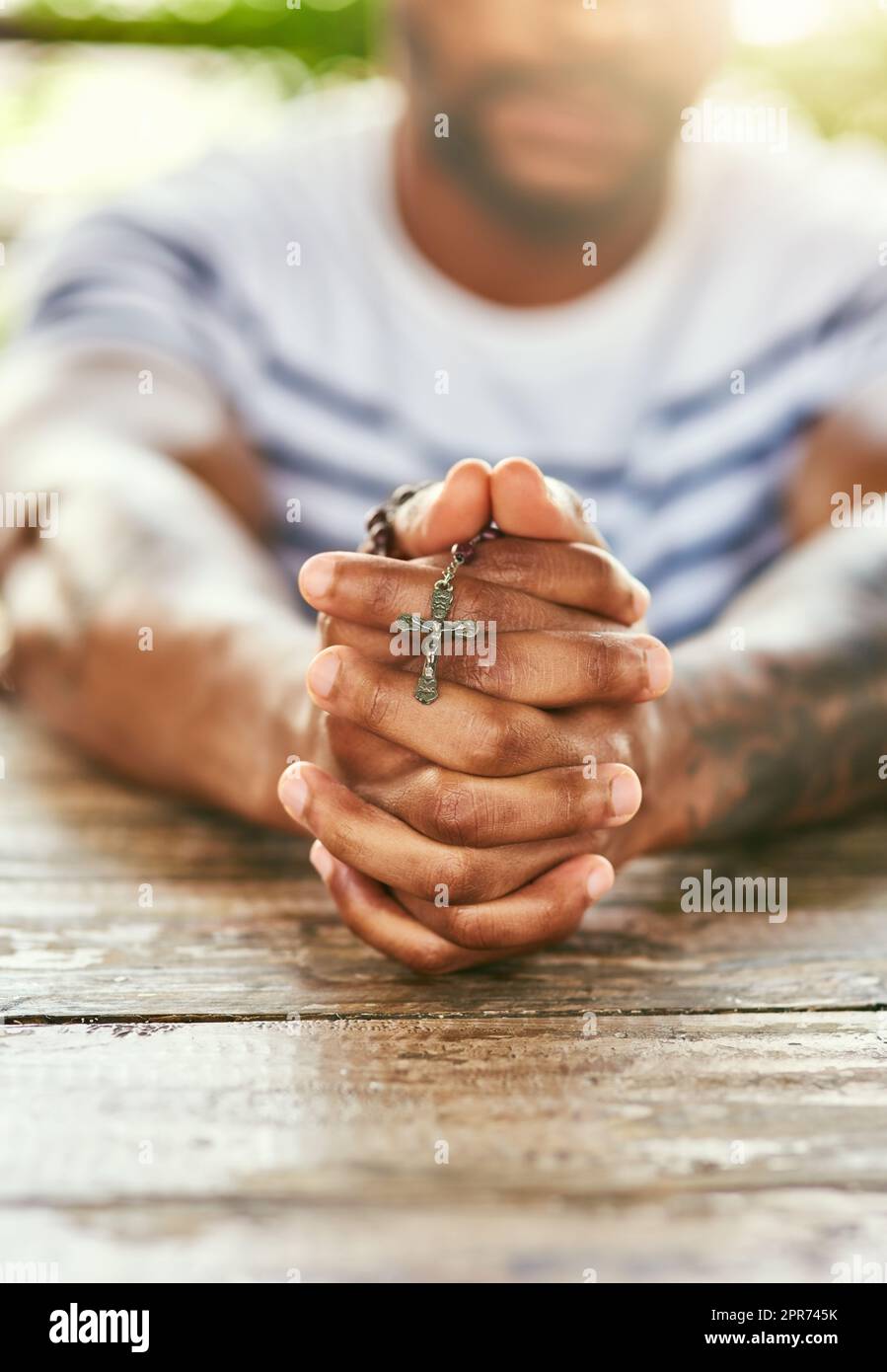 Praying man holding a rosary hi-res stock photography and images - Alamy
