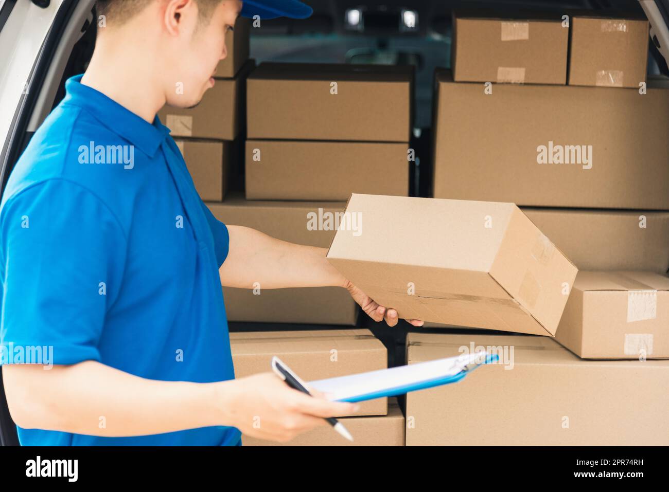 man courier in uniform hold documents clipboard checking list parcel ...