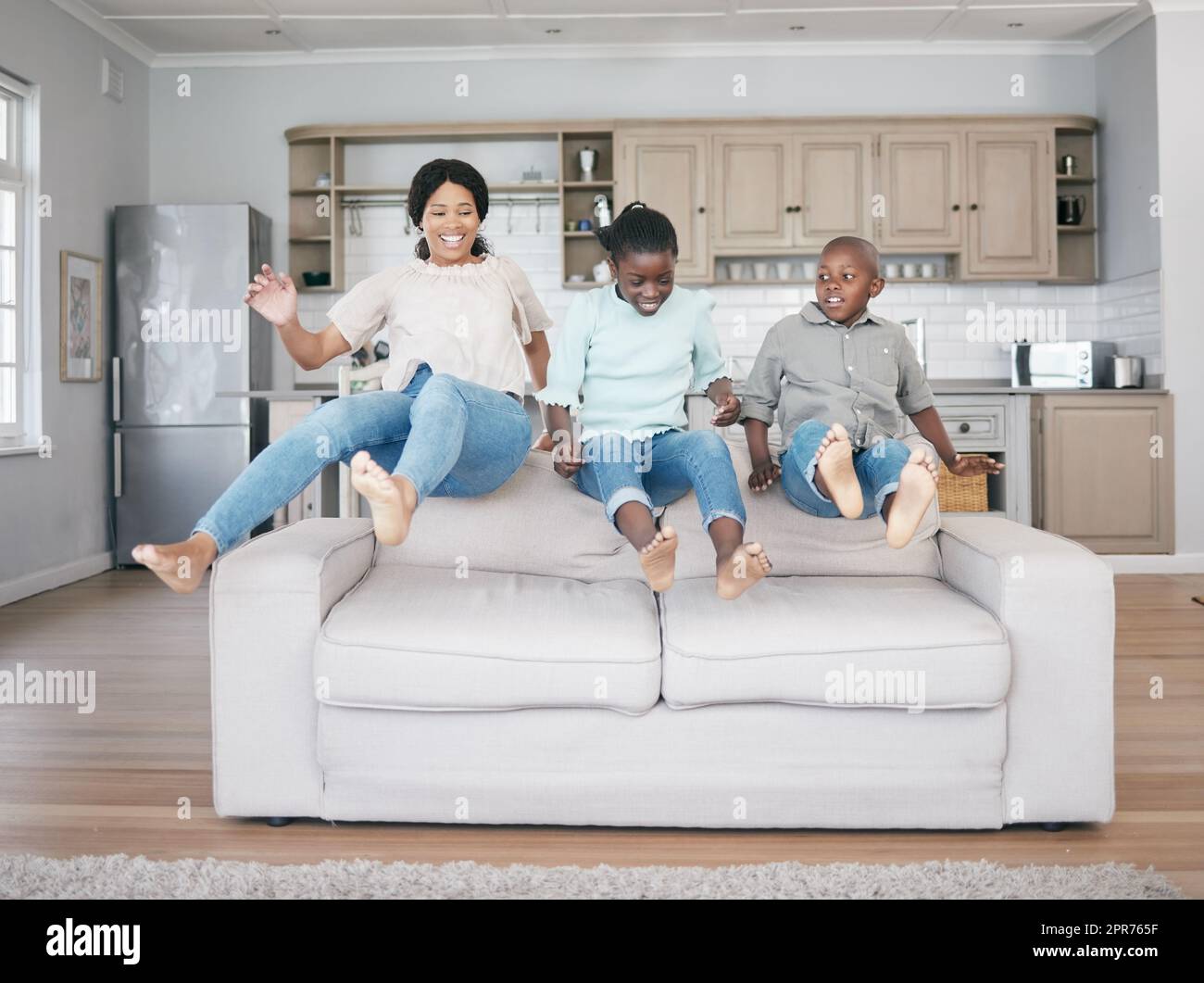 Boy jumping couch hi-res stock photography and images - Alamy