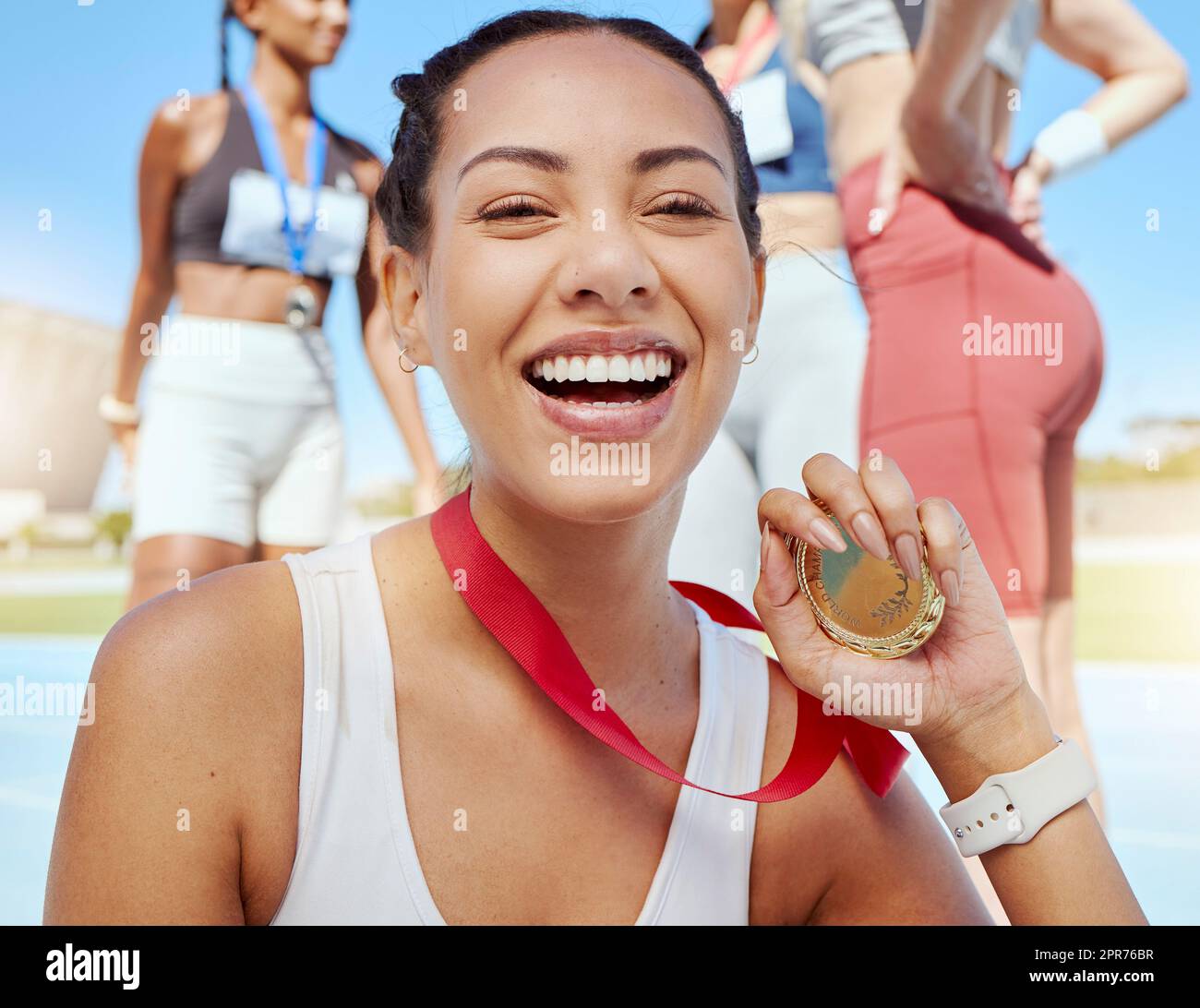 Closeup portrait of mixed race athletic woman showing gold medal from ...