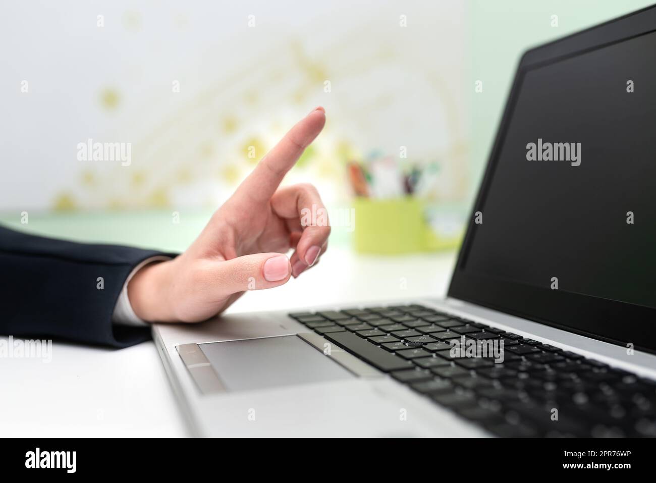 Businesswoman With Lap Top On Desk Pointing Important Messages With One ...