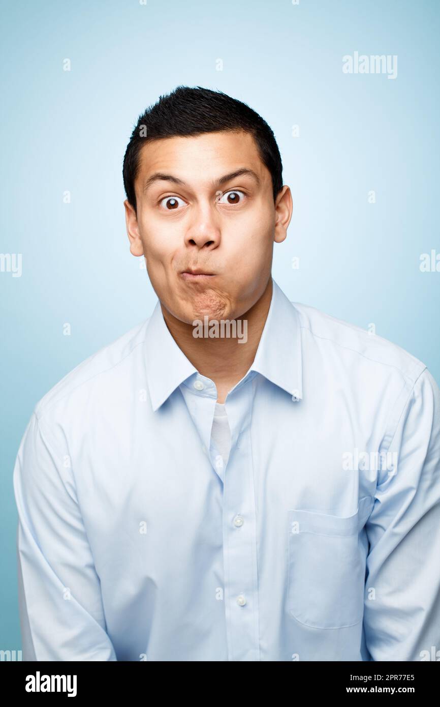 Be silly while you can. Shot of a young man making facial expressions ...