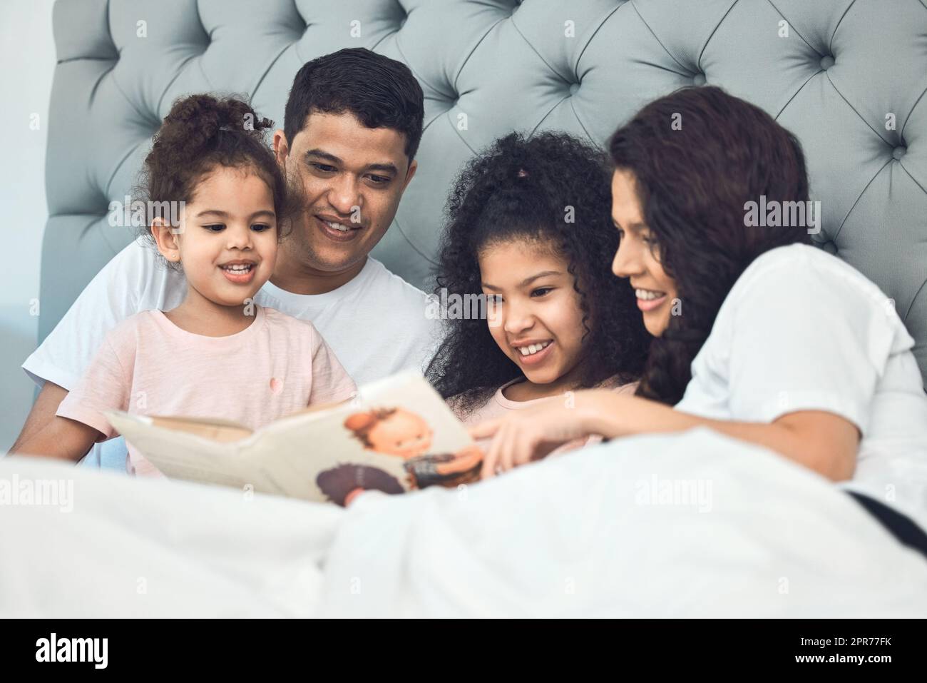 Family Reading Together In Bed