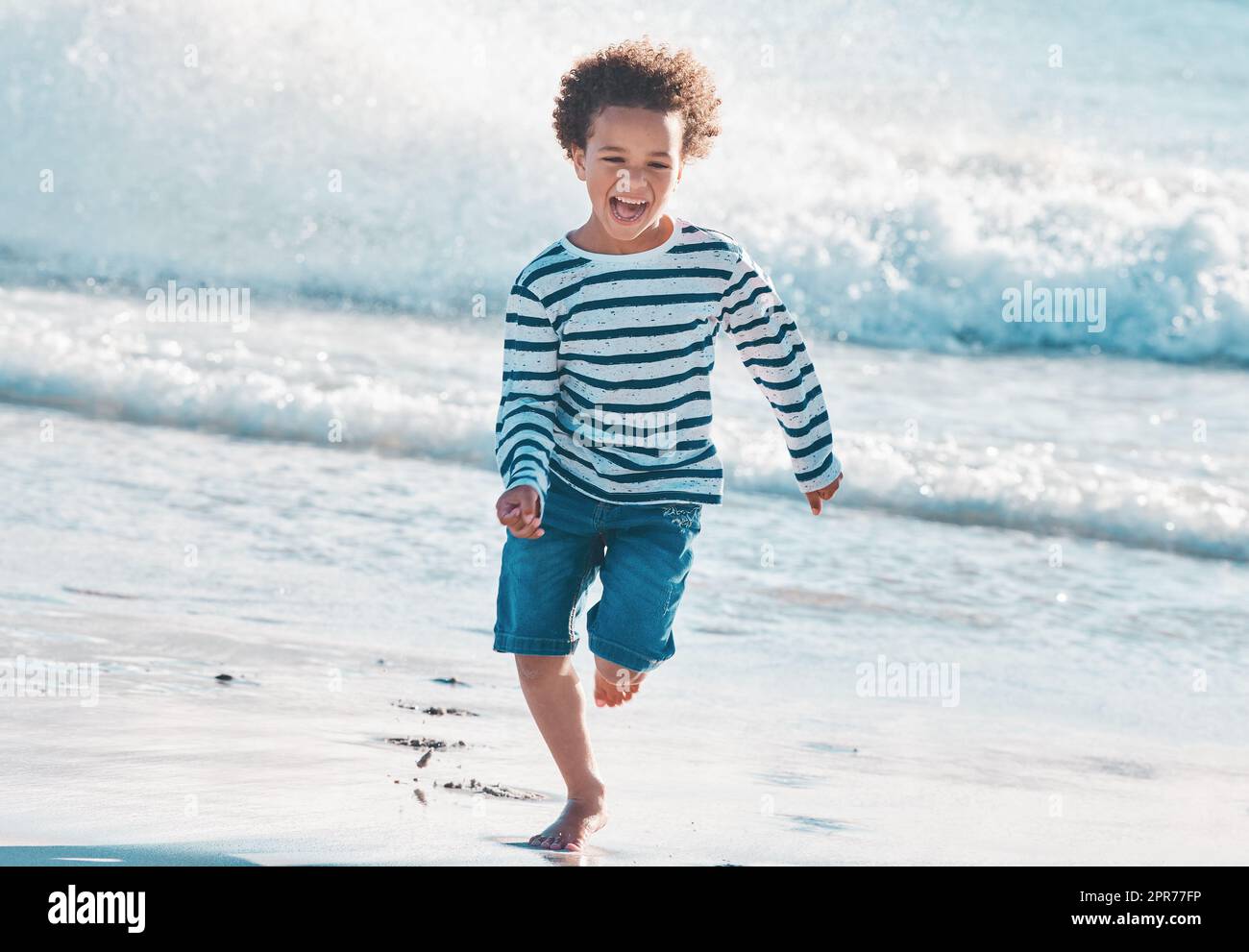 Shot of an adorable little boy running on the beach Stock Photo - Alamy