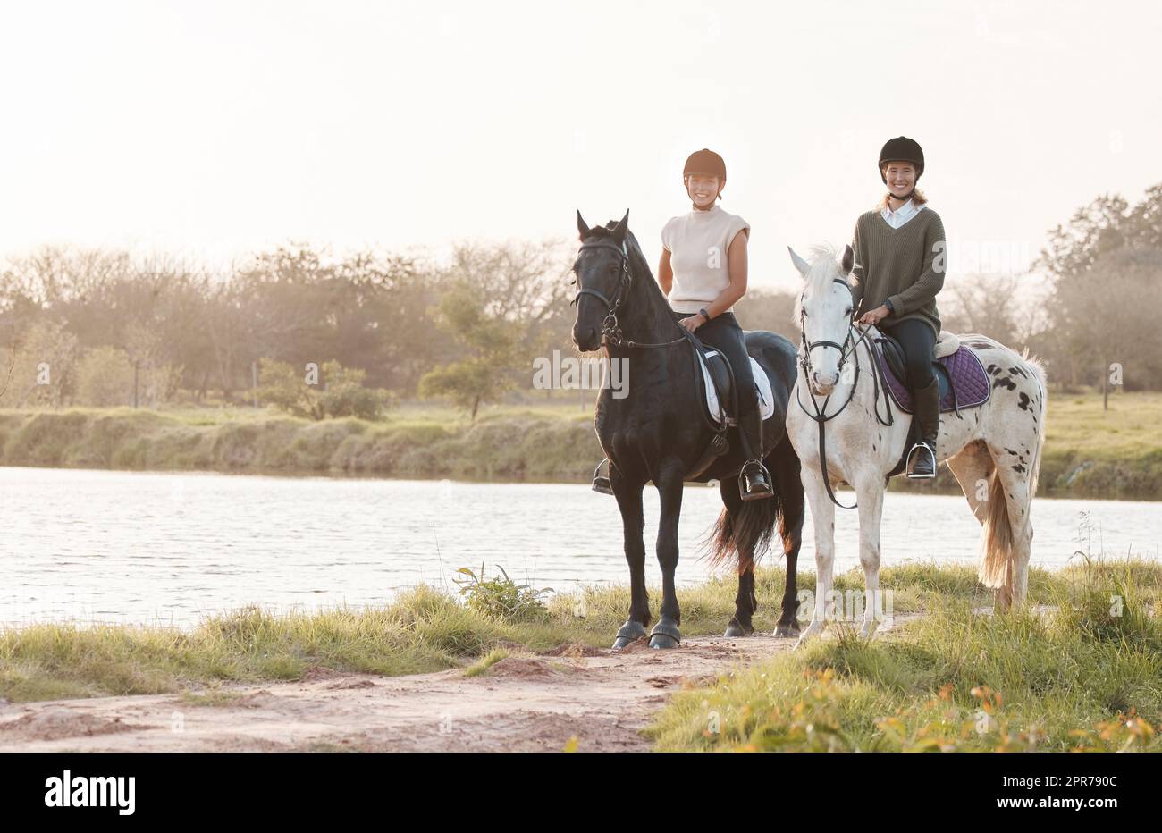 Exploring on horseback is as relaxing as it gets. Shot of two young ... Exploring on horseback is as relaxing as it gets. Shot of two young ...