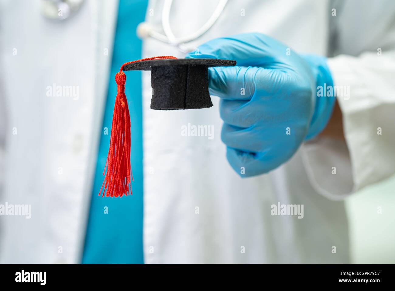 Asian doctor study learn with graduation gap hat in hospital ward ...