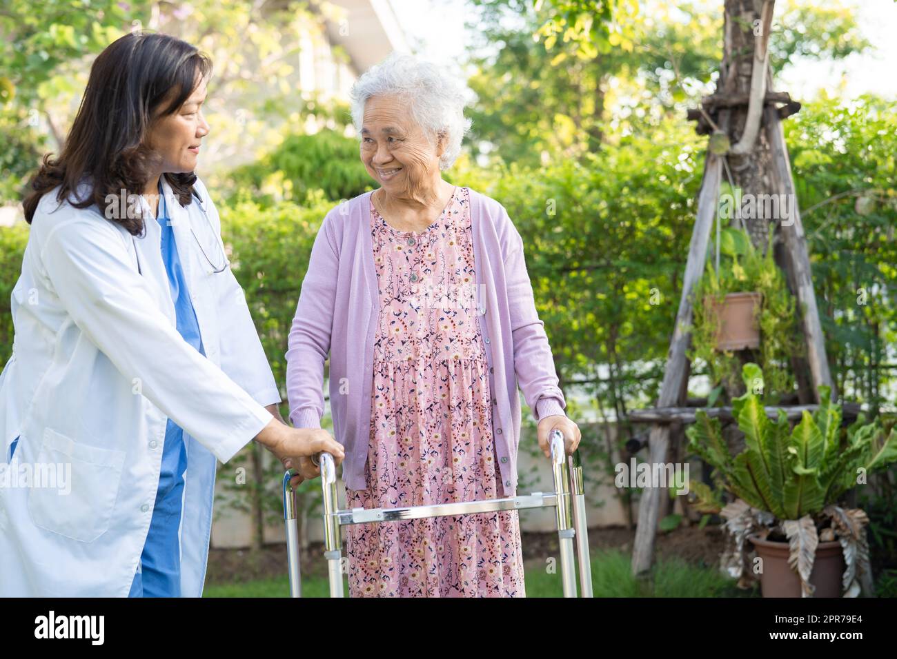 Help and care Asian senior or elderly old lady woman use walker with ...