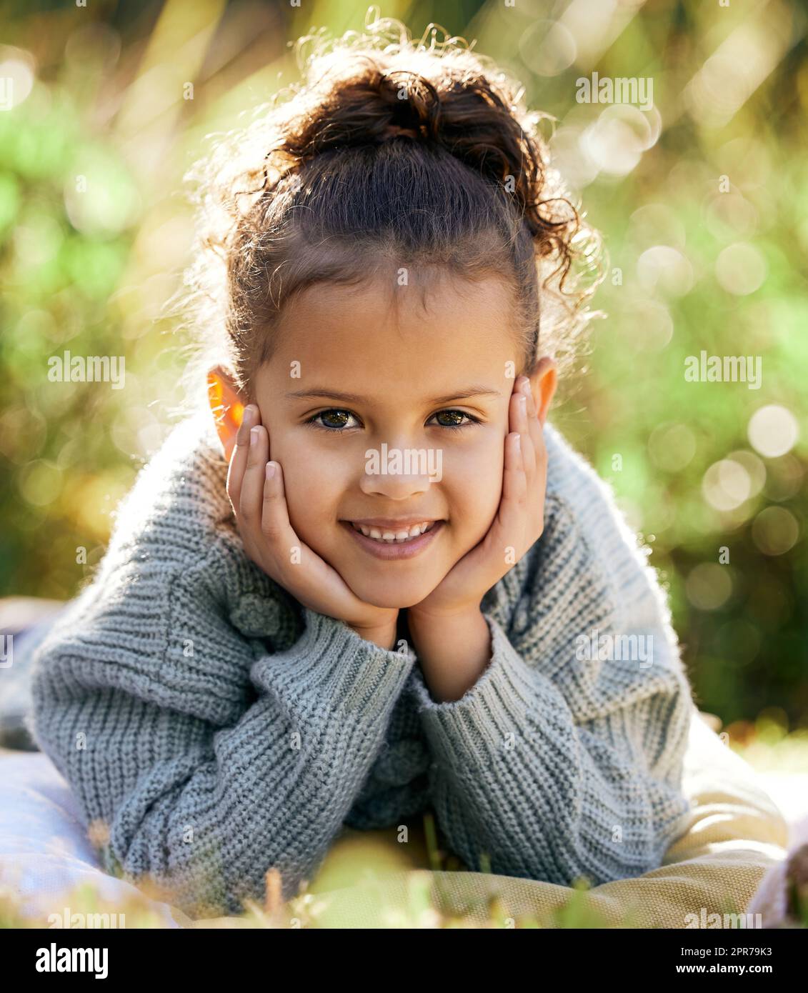 Happy girls love being in nature. a little girl spending time at a park ...