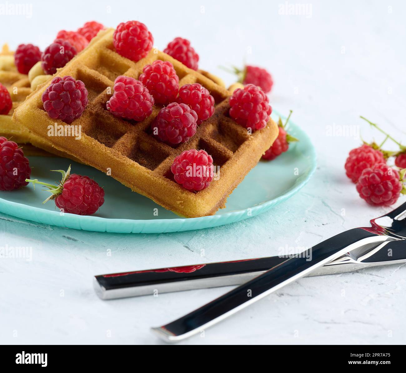 Stack of baked Belgian waffles with ripe red raspberry Stock Photo - Alamy