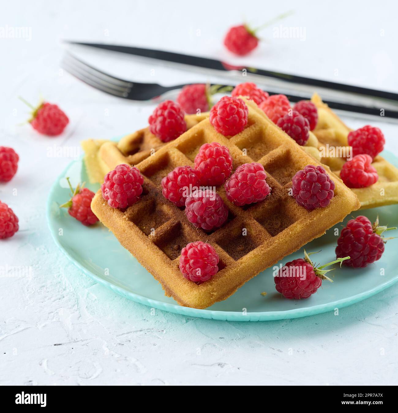 Stack of baked Belgian waffles with ripe red raspberry Stock Photo - Alamy