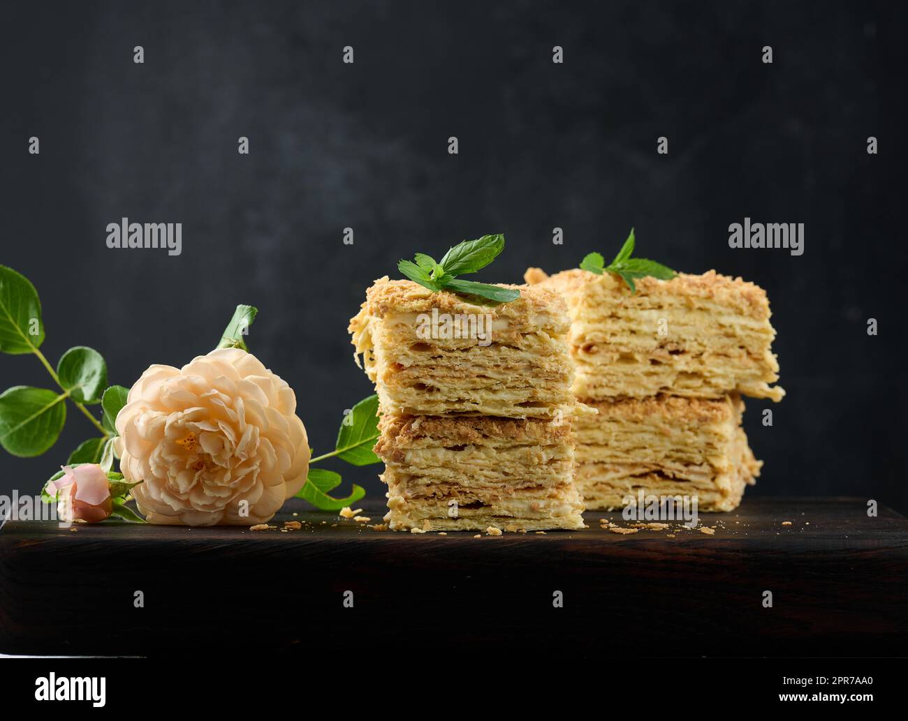 A stack of baked Napoleon pie slices with cream. Puff pastry, delicious ...