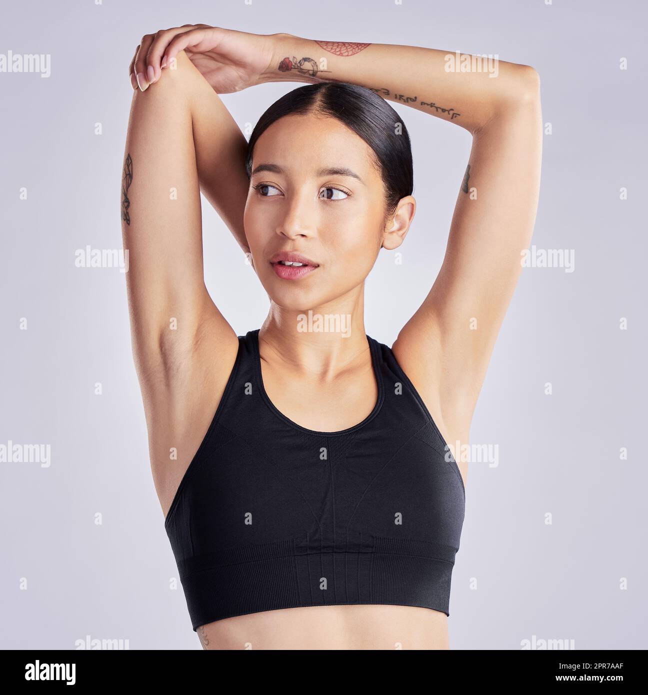 Stretch out yesterdays training session. an attractive young woman ...