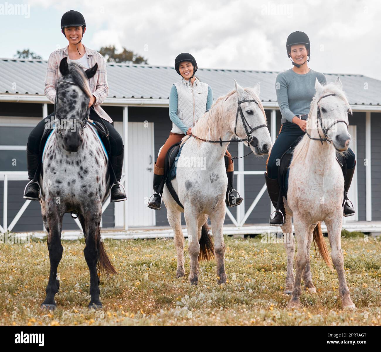 On horseback. Full length portrait of three attractive young women ...