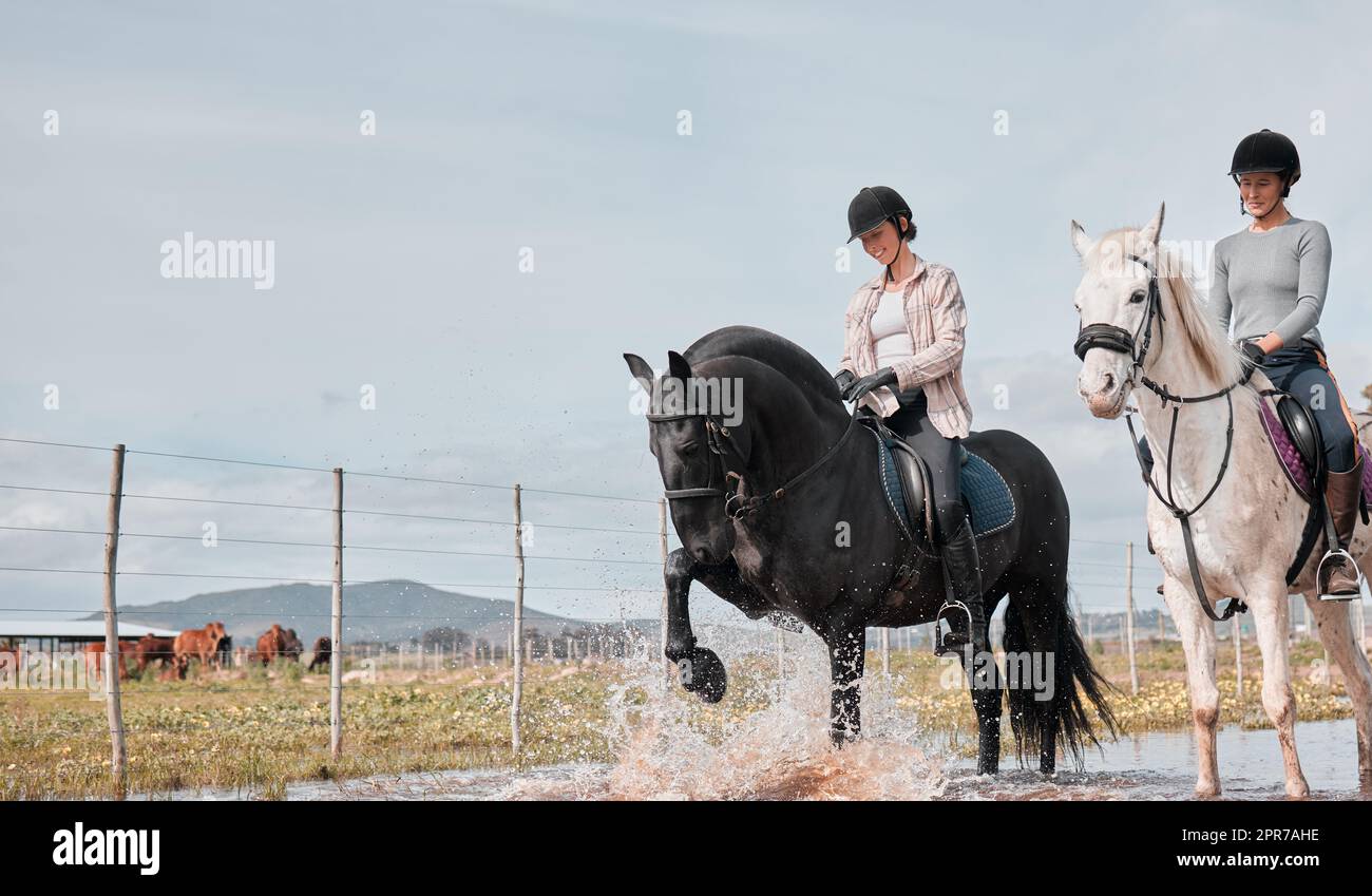 Raring to go. Full length shot of two attractive young women riding ...