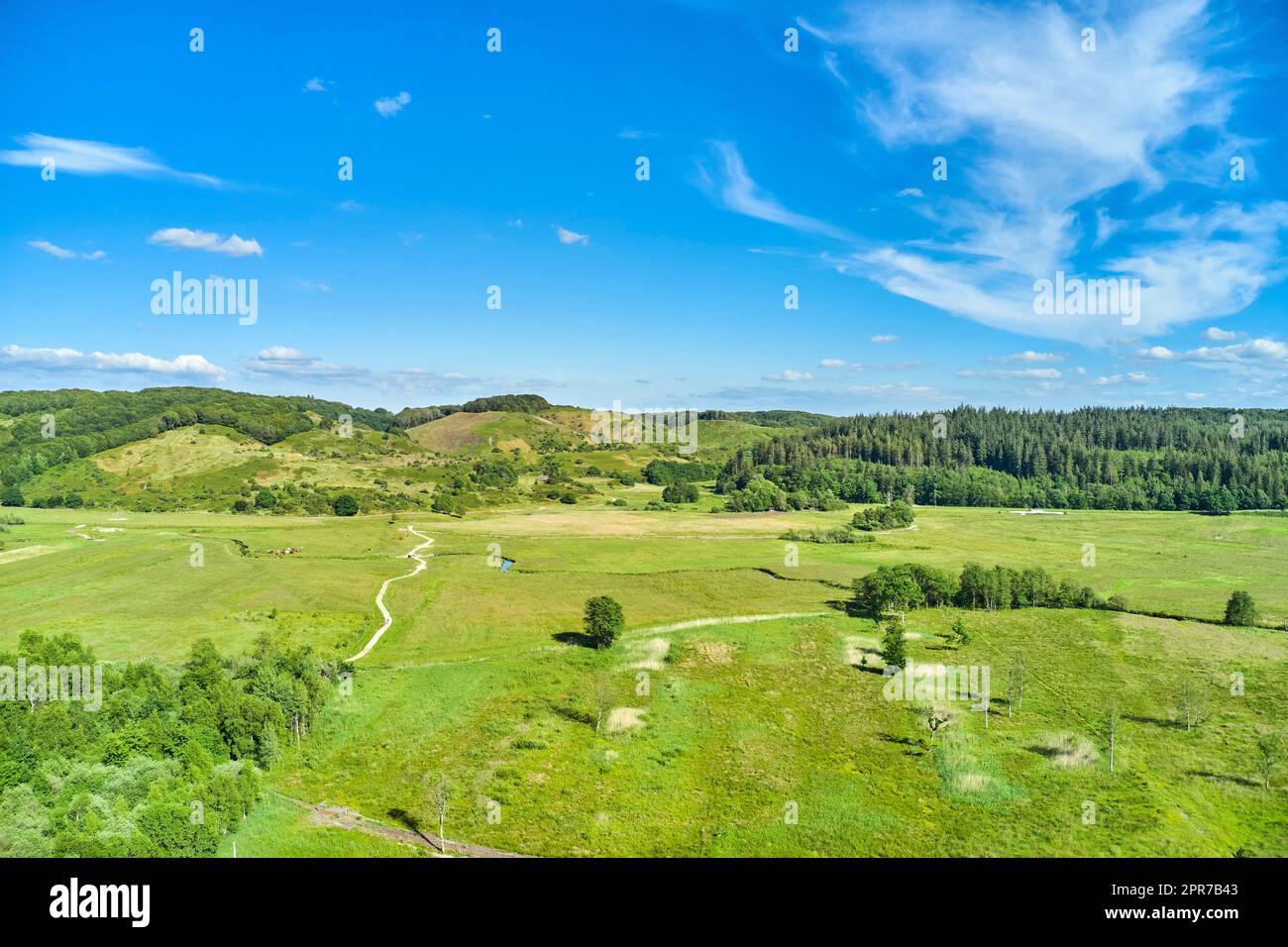 Landscape of a countryside with a cloudy blue sky and copyspace. Wide ...