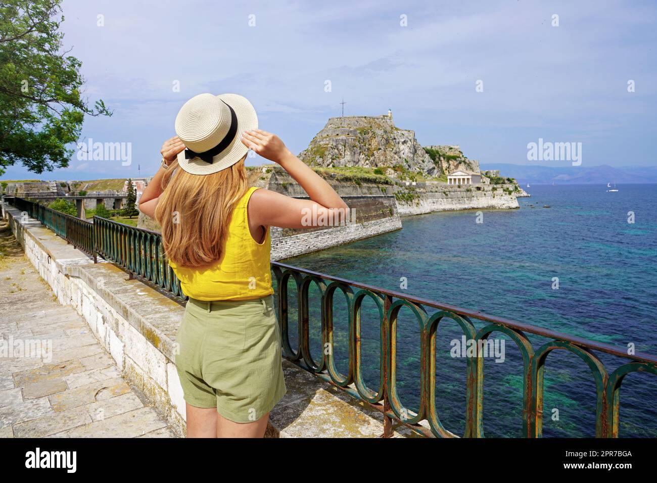 Tourism in Corfu, Greece. Back view of traveler girl enjoying view of ...