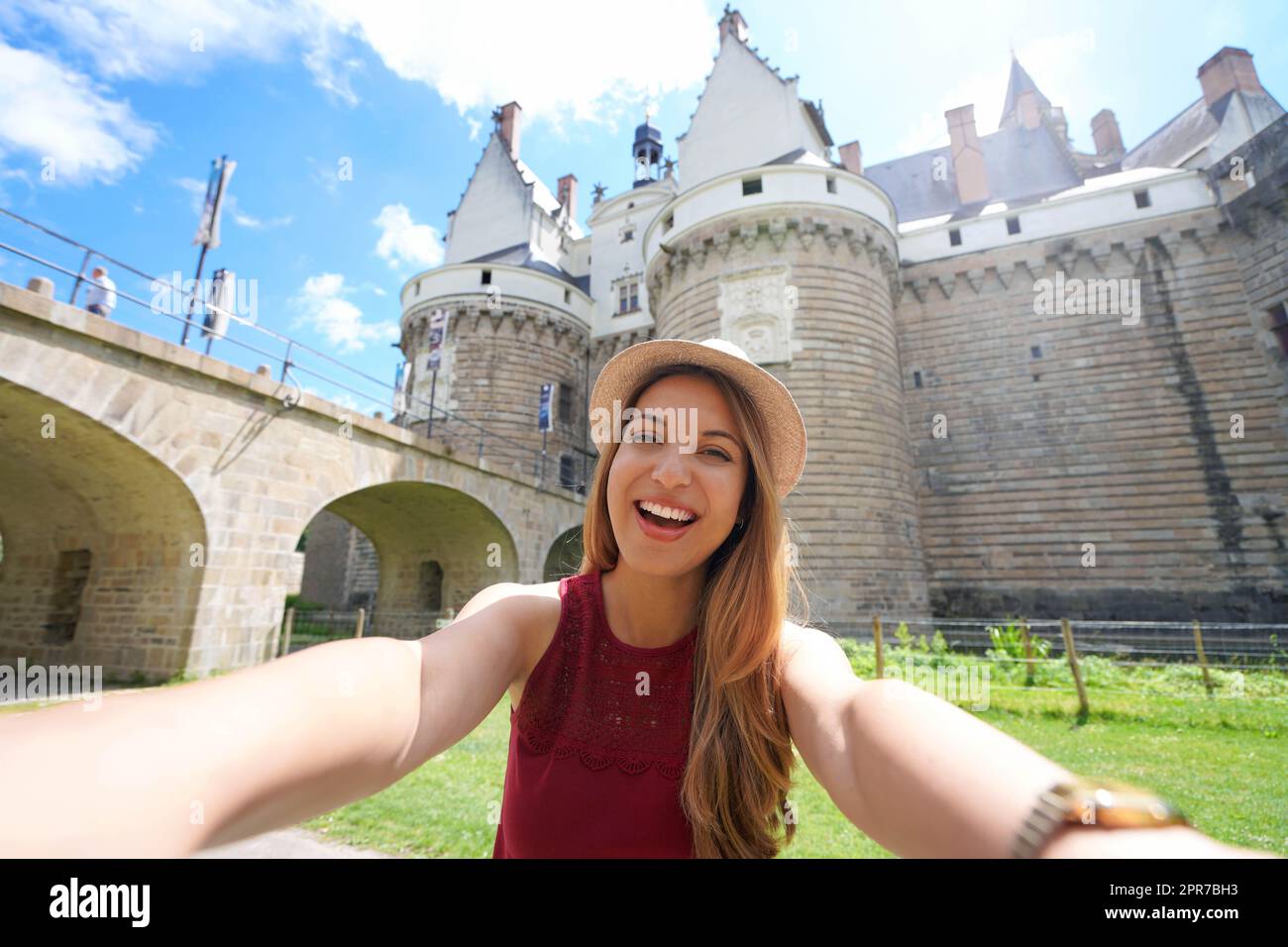 Happy traveler girl taking selfie photo with Nantes Castle on the ...