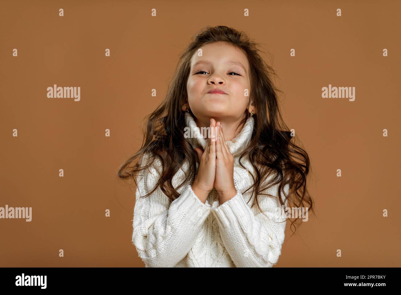 happy beautiful curly little girl asking for something Stock Photo - Alamy