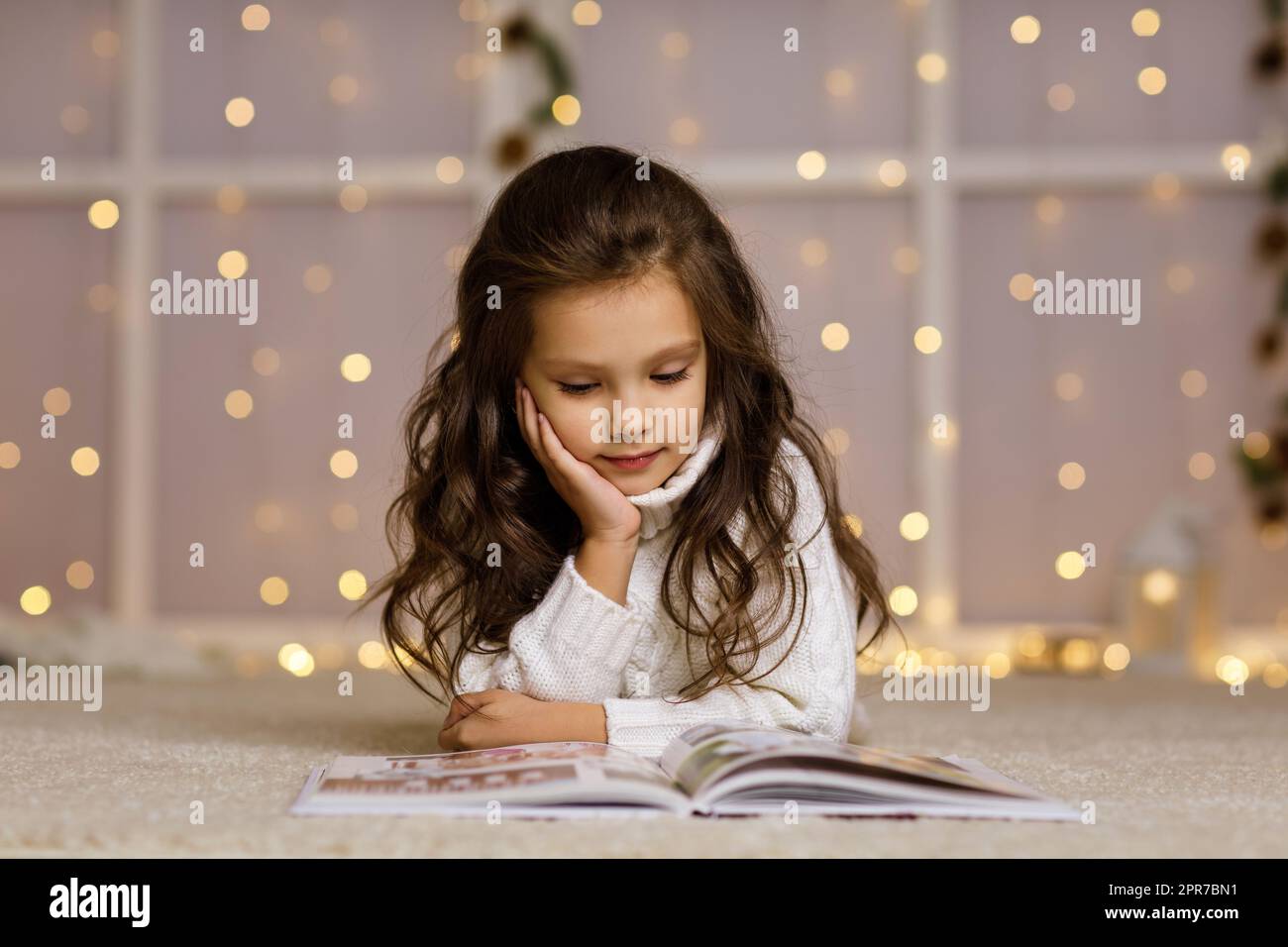 child girl is reading book Stock Photo - Alamy