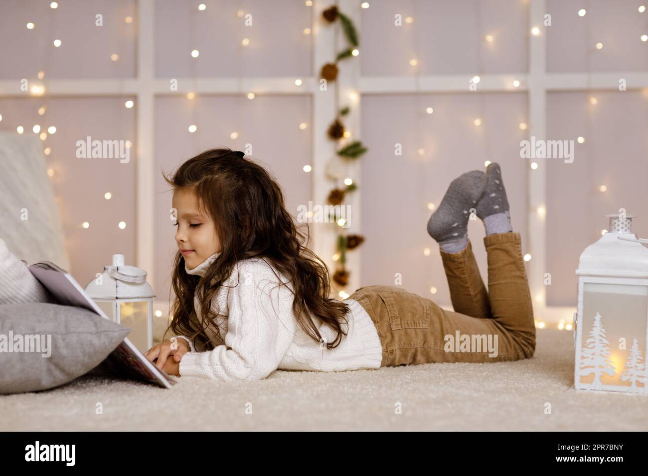 child girl is reading book Stock Photo - Alamy
