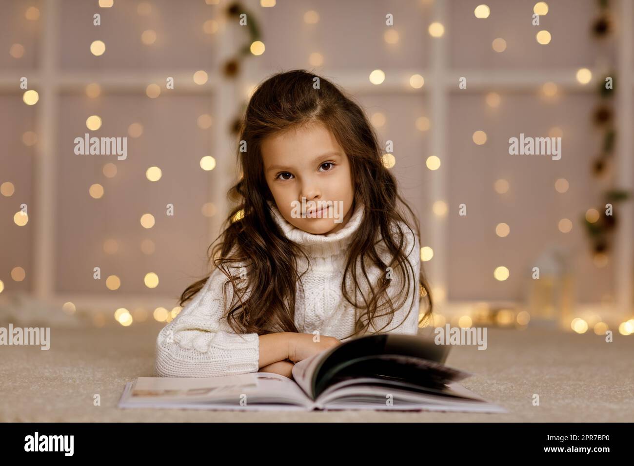 child girl is reading book Stock Photo - Alamy