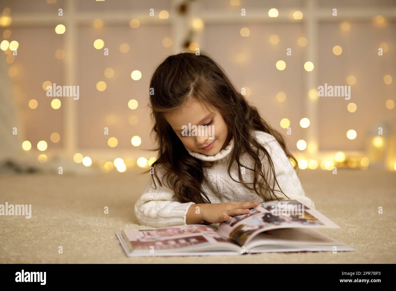 child girl is reading book Stock Photo - Alamy