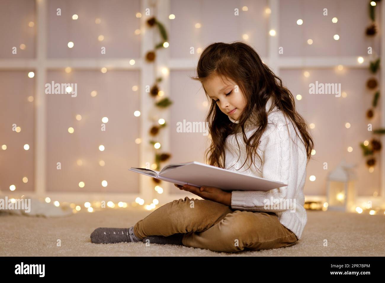 child girl is reading book Stock Photo - Alamy