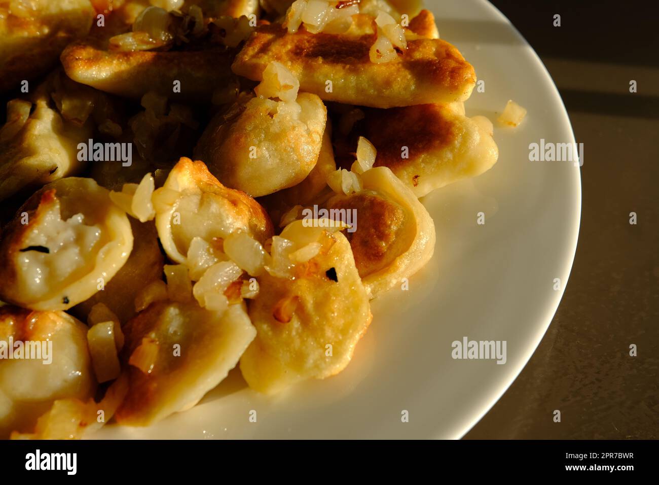 Homemade potato dumplings or vereniki pierogi, served with fried onions ...