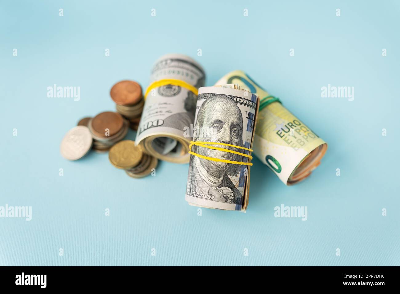 International money dollar bills, coins lie next to money twisted ...