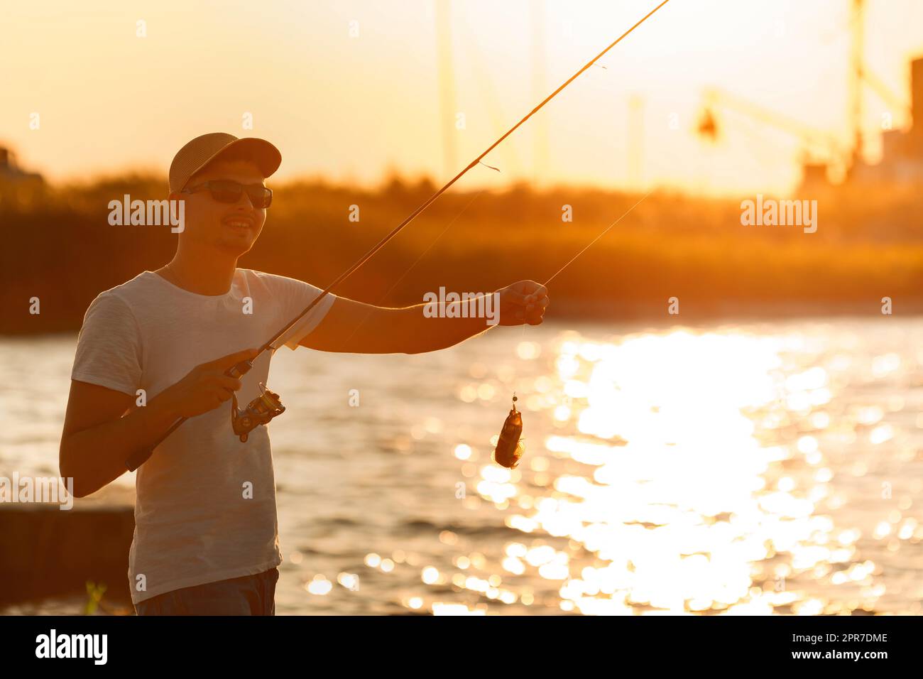 Young man fish fishing hi-res stock photography and images - Alamy