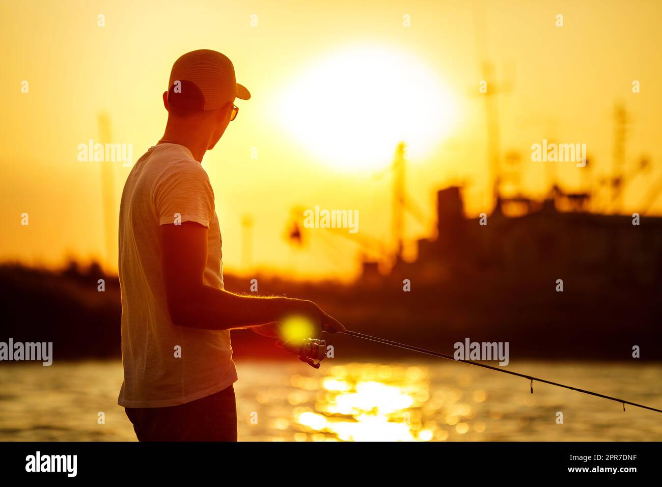Silhouette young man fishing hi-res stock photography and images - Alamy