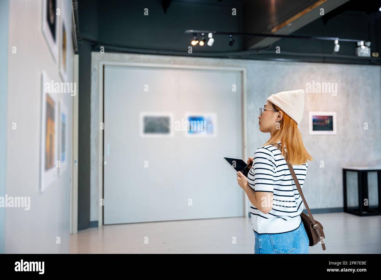 Young person at photo frame write digital book at show exhibit artwork ...