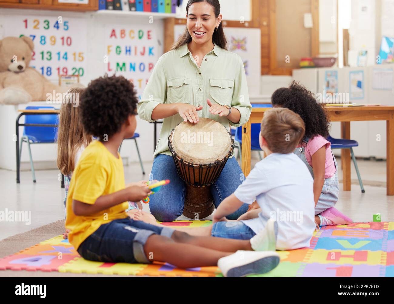 This is how you play it. Shot of a woman teaching her class about ...