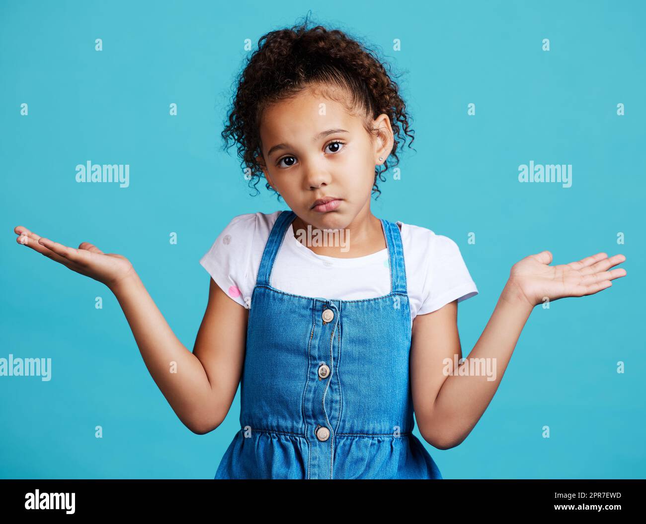 How should I know. Shot of an adorable little girl shrugging while ...