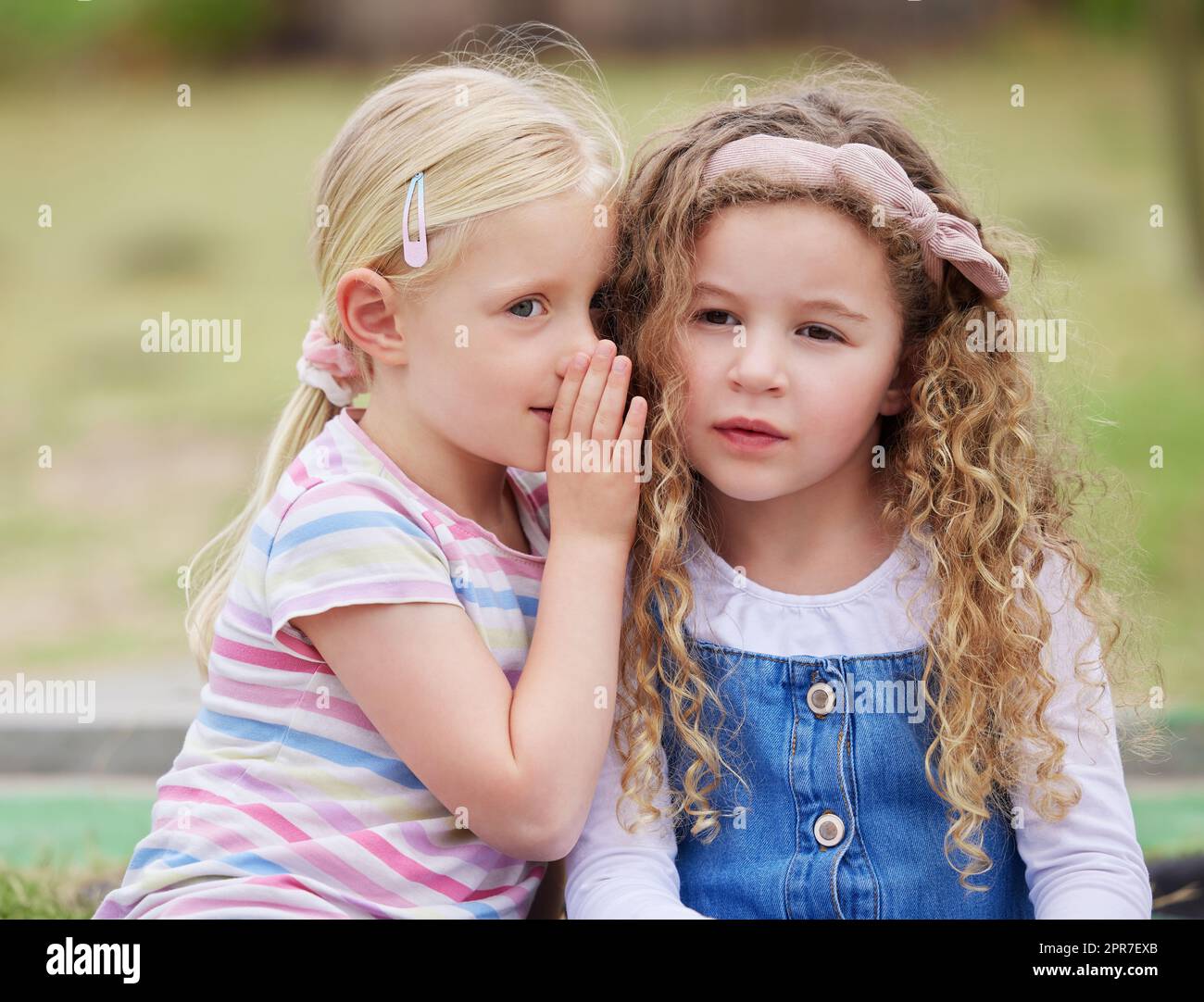 Child whispering in her ear hi-res stock photography and images - Alamy