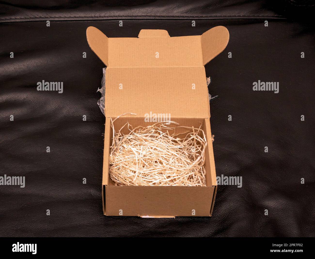 Open cardboard package with paper protection Stock Photo - Alamy
