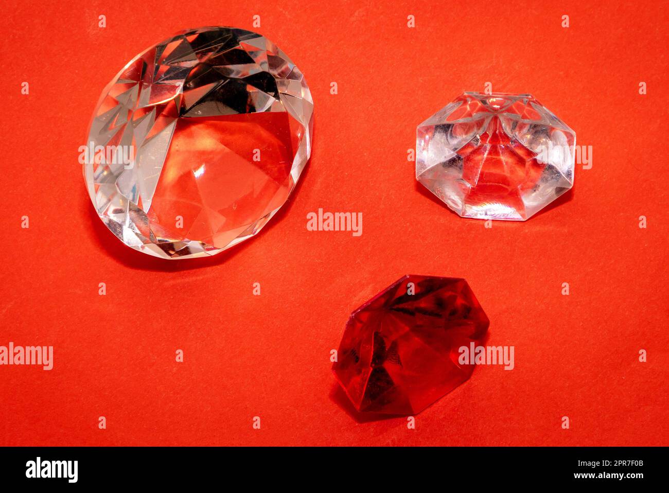 Sparkling diamonds on red background Stock Photo - Alamy