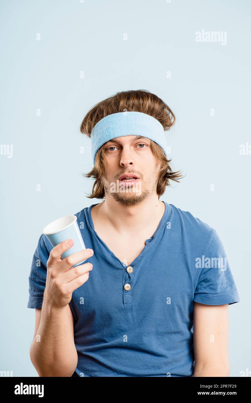 Wheres the coffee machine. Shot of a handsome young man sitting alone ...