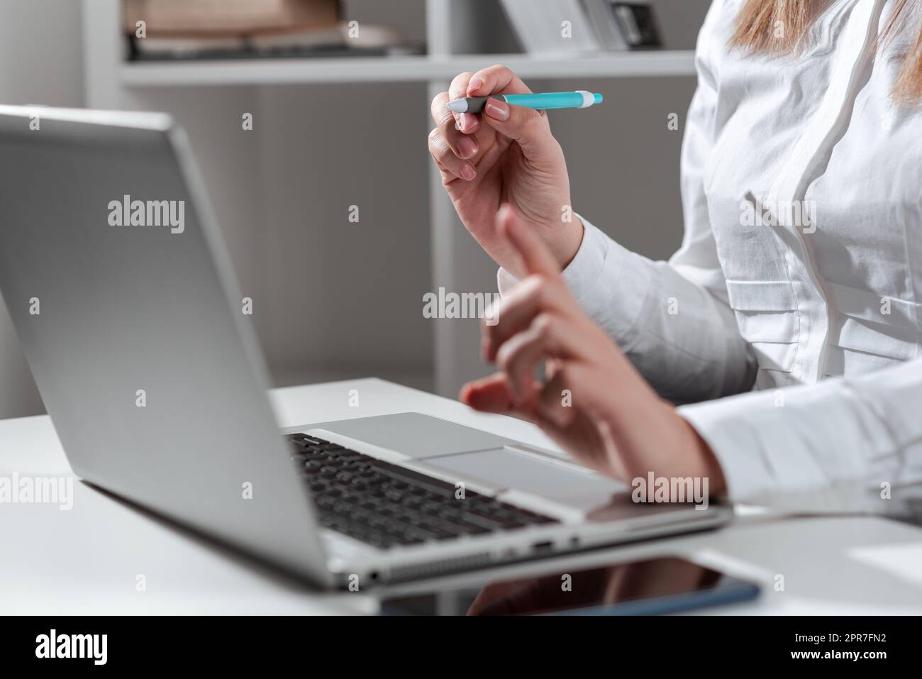 Businesswoman Typing Recent Updates On Lap Top And Pointing Important ...
