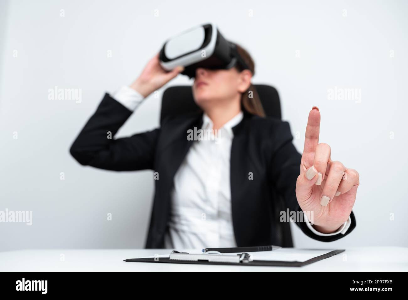 Female Executive Wearing Virtual Reality Simulator Gesturing During ...