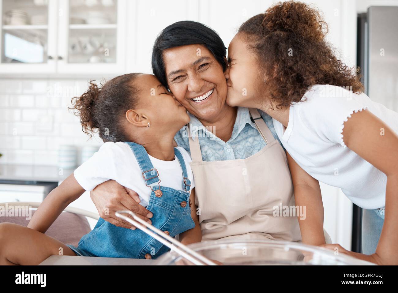 Two cute little sisters kissing hi-res stock photography and images - Alamy