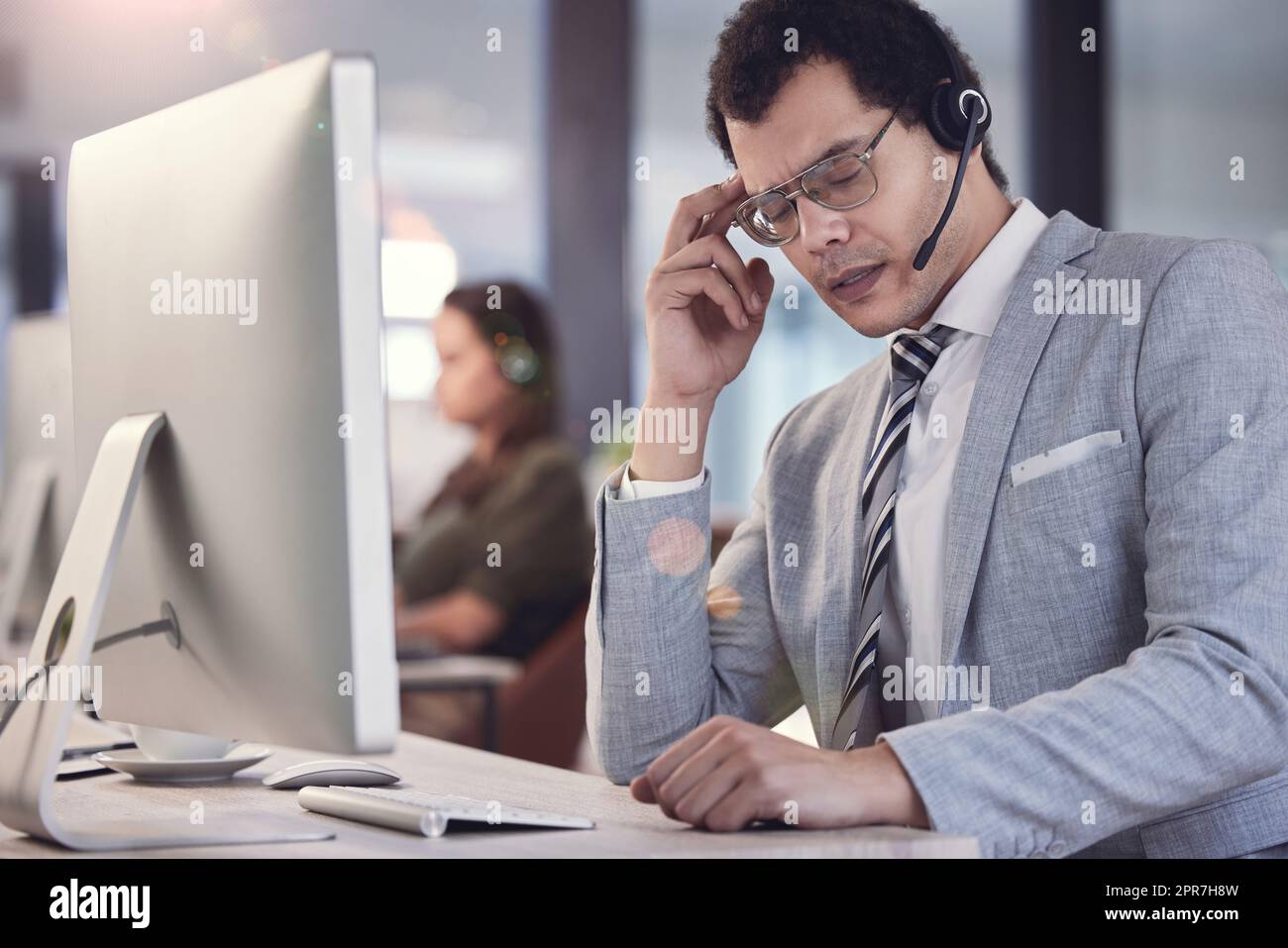 Im feeling a bit stressed. a young male call center agent suffering ...