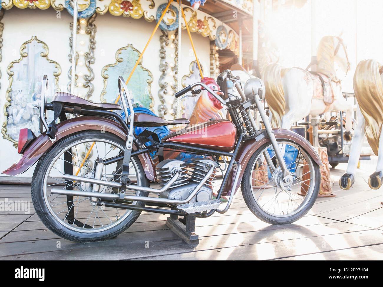 toy motorcycle on carousel in an amusement park in Ukraine on Sunset ...
