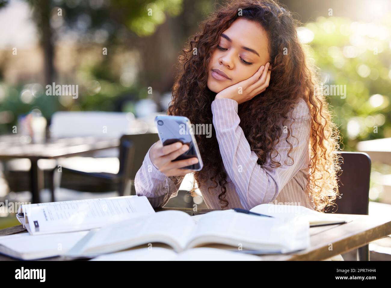 That seems like more fun. a young female student using a phone while ...